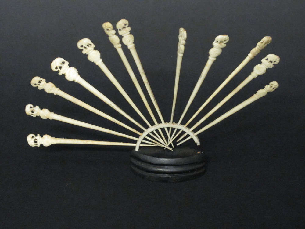 A set of 12 carved ivory cocktail sticks, raised on a | 5th September ...