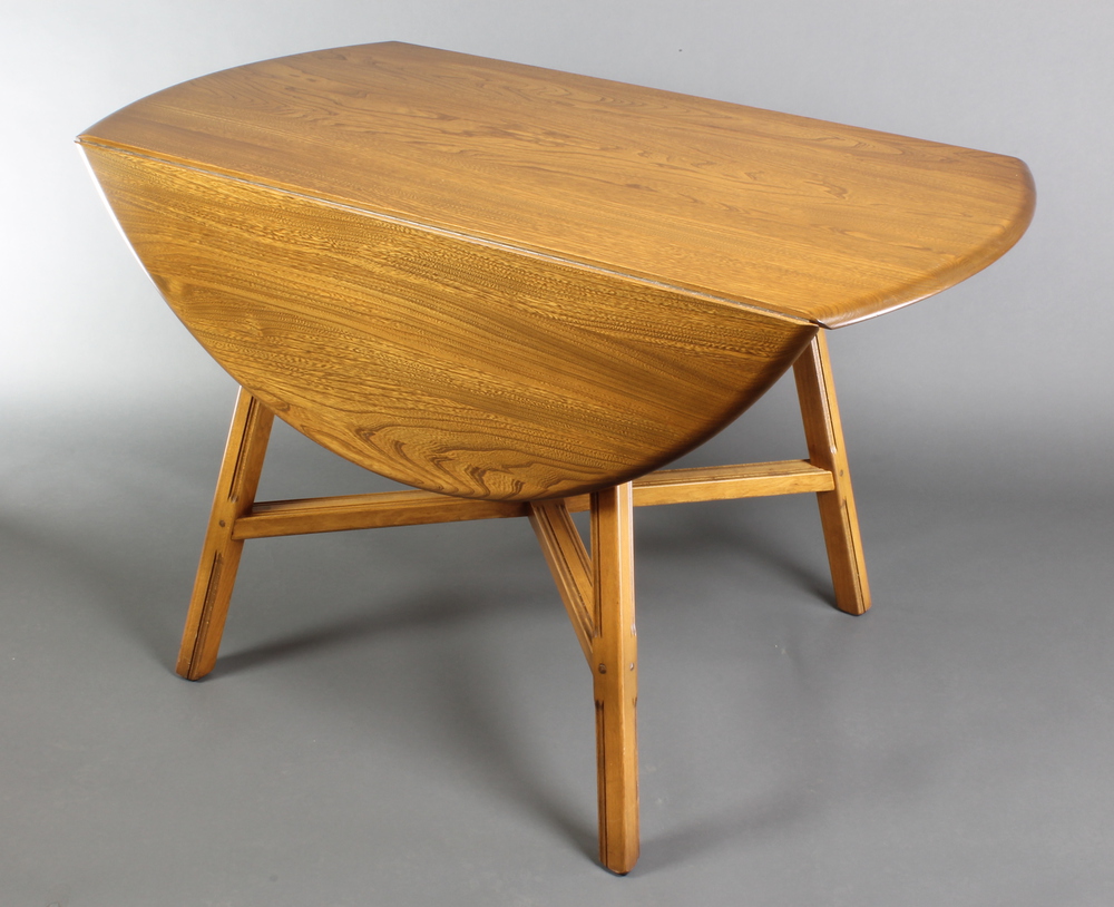 An Ercol light elm oval drop flap dining table raised | 20th January ...