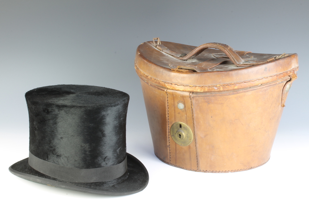 A light brown leather top hat box containing a black | 10th October ...