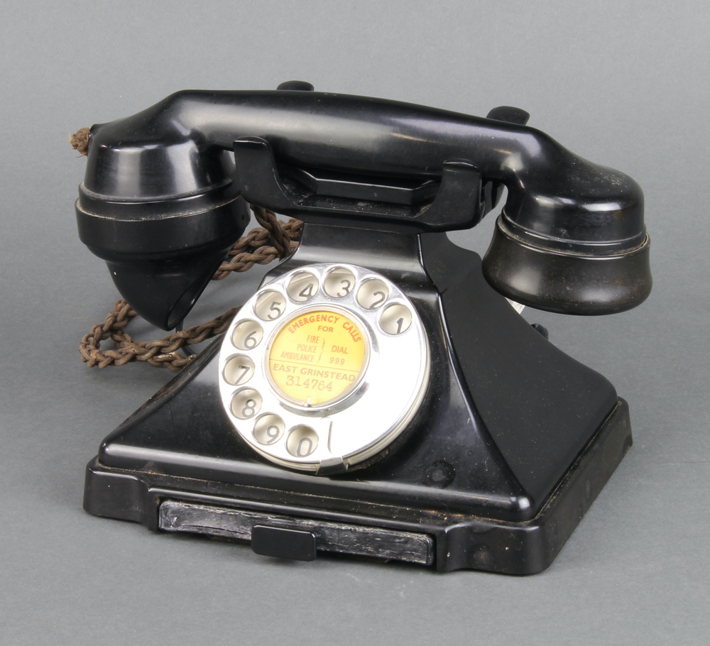 A black Bakelite dial telephone raised on a | 10th February 2022 | Denhams