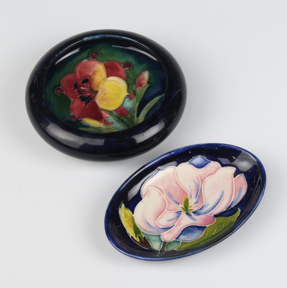 A Moorcroft oval pin tray with blue ground decorated a | 10th March ...