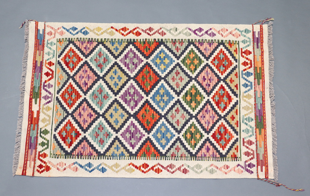 A white, green and orange ground Chobi Kilim with all | 7th April 2022 ...