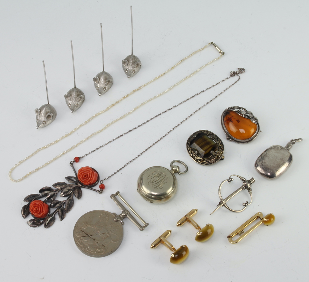 A silver mounted amberoid brooch, a coral pendant and | 4th May 2022 ...