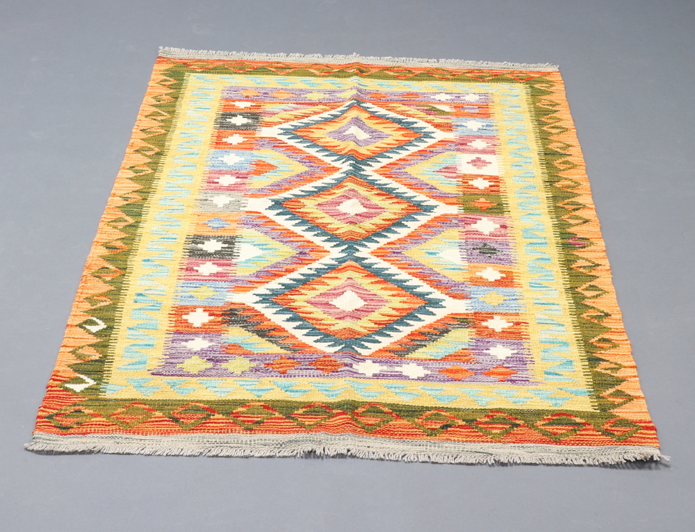 A green, brown and orange ground Chobi rug with 3 | 4th May 2022 | Denhams