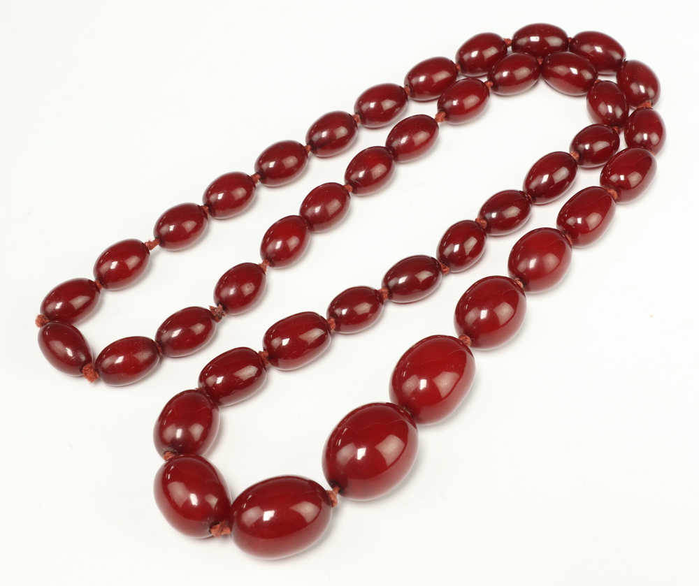A red amberoid graduated bead necklace 84cm | 15th June 2023 | Denhams