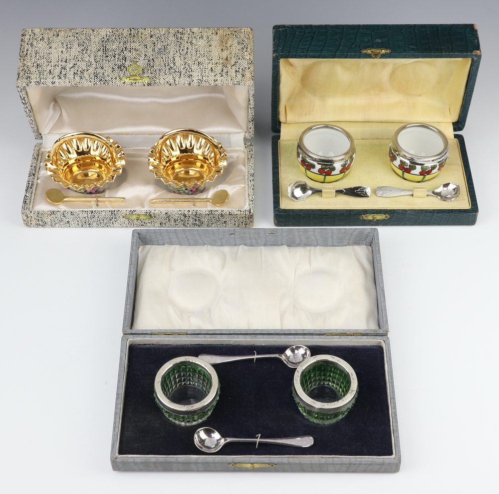 A cased pair of silver mounted green glass condiments | 21st March 2024 ...