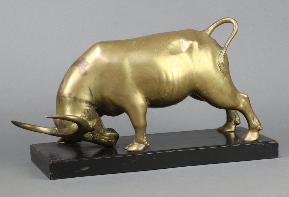 A gilt metal model of a standing bull raised on a | 12th June 2024 ...