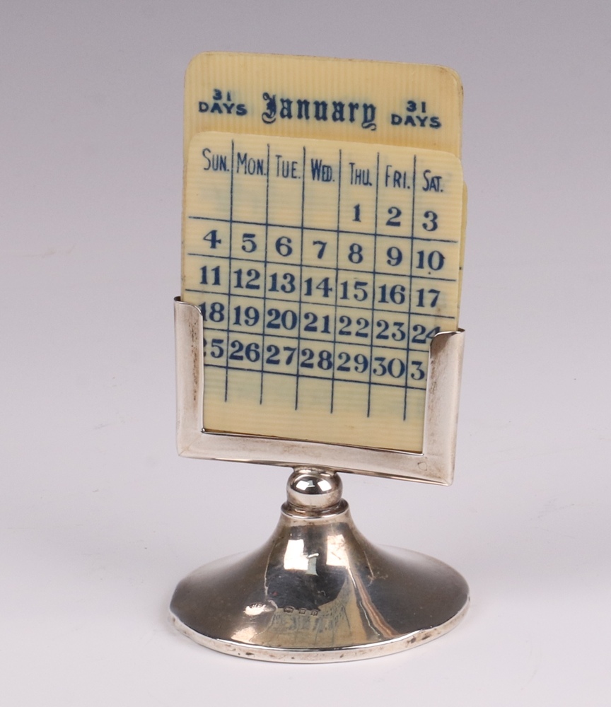 A silver perpetual calendar, raised on a circular | 28th January 2026 ...